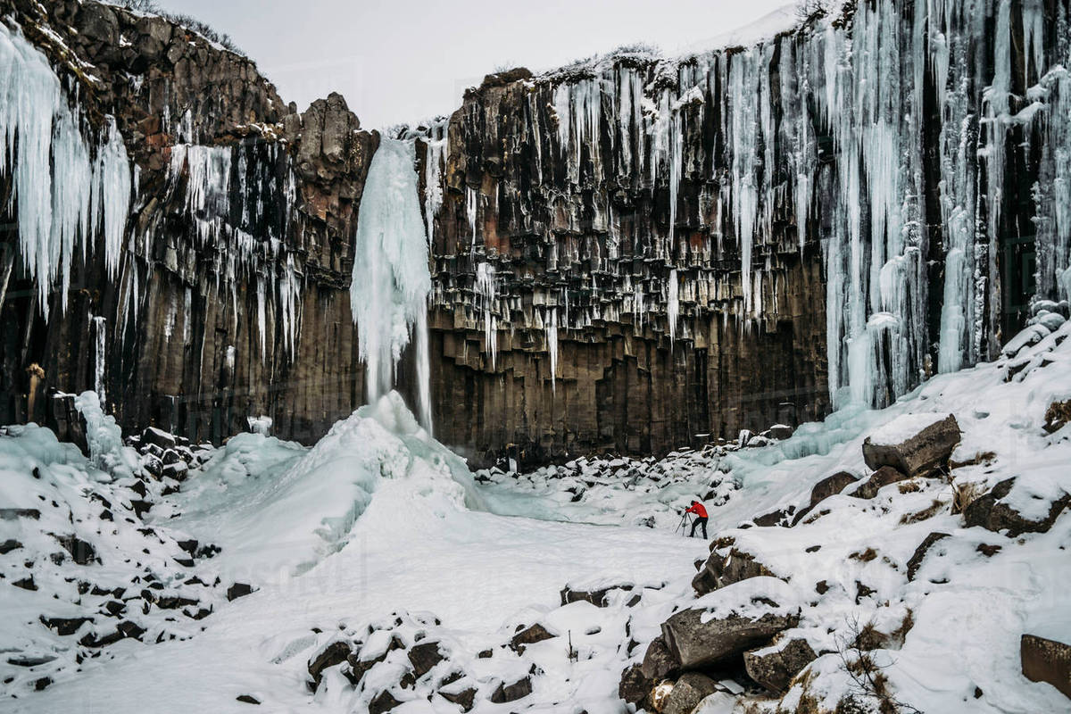 Icicle formations hanging over craggy cliff, Iceland - Royalty-free ...