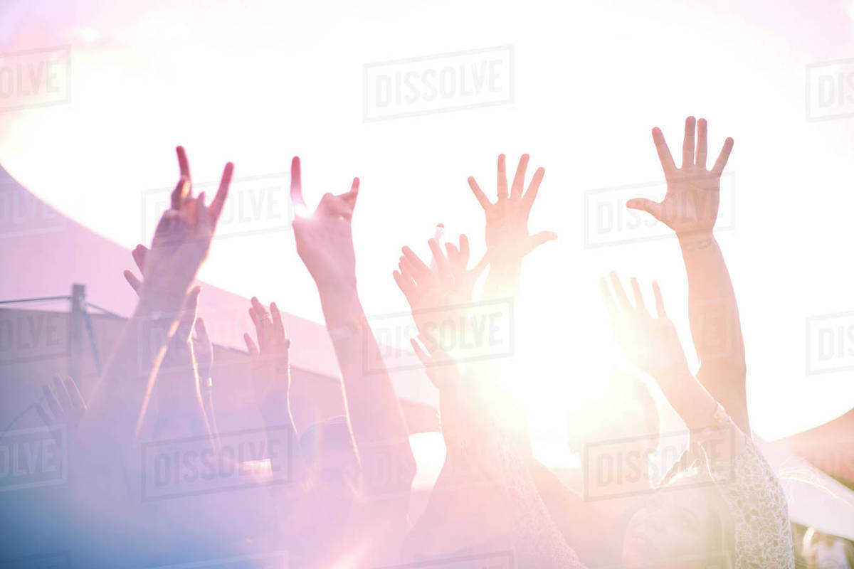 Arms raised cheering at sunny music festival - Royalty-free Stock Photo ...