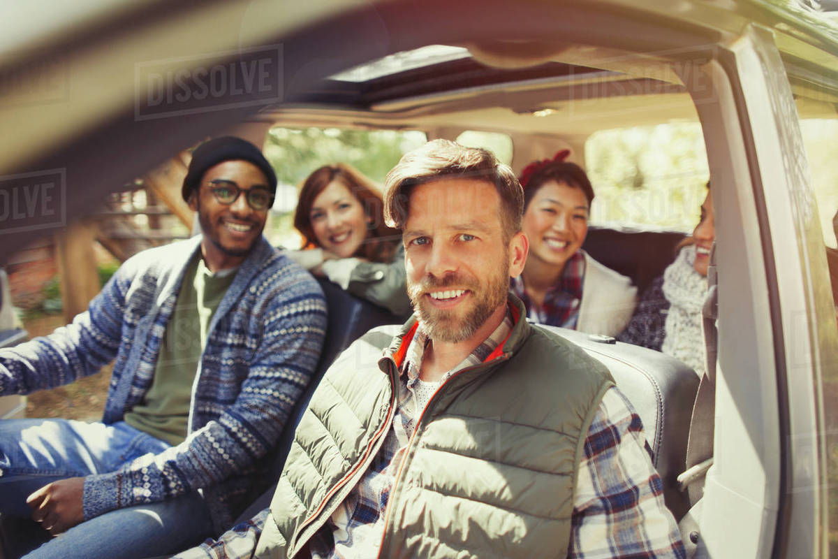 Portrait smiling friends inside car - Royalty-free Stock Photo | Dissolve