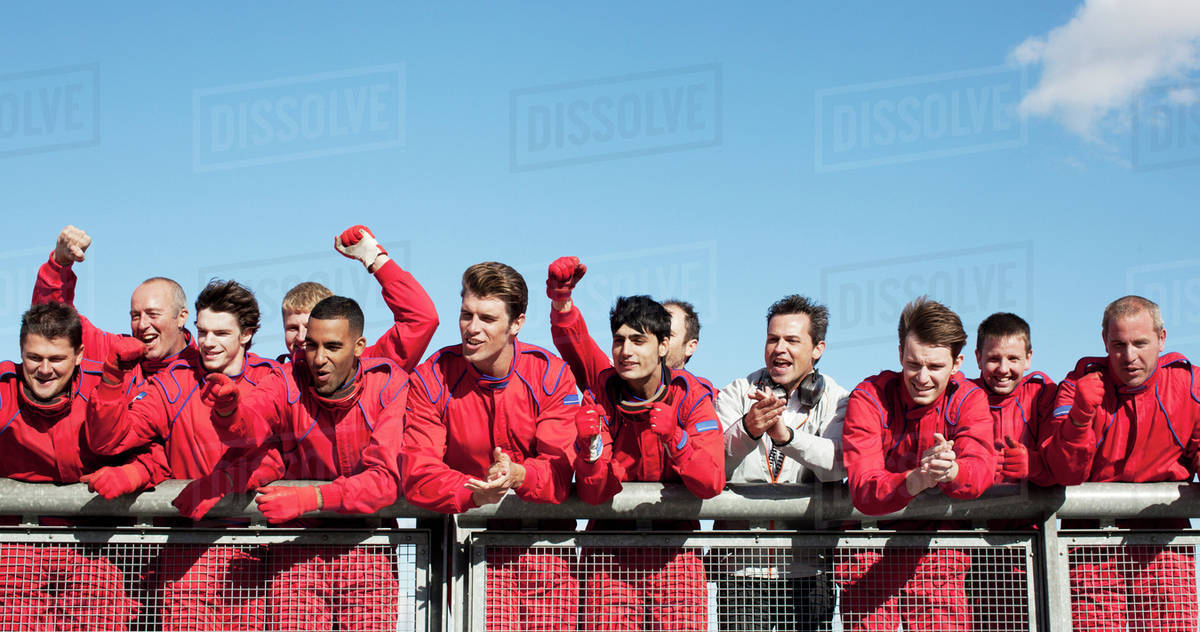 Racing team cheering on sidelines - Royalty-free Stock Photo | Dissolve