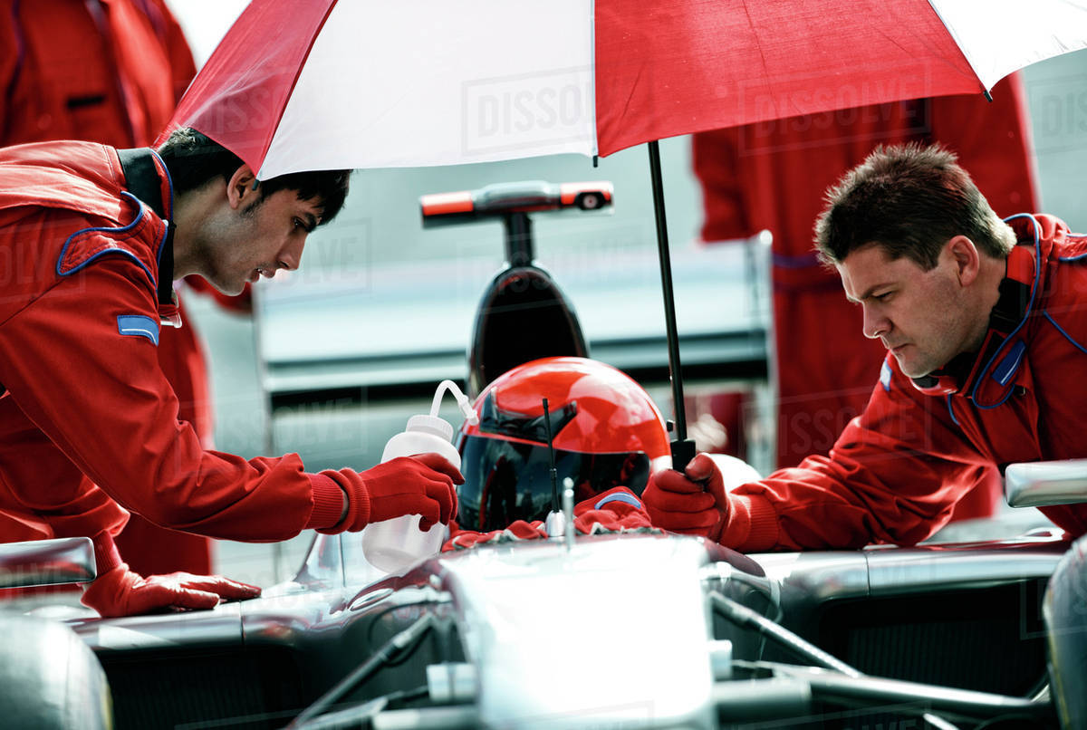 Racer and team working in pit stop - Royalty-free Stock Photo | Dissolve