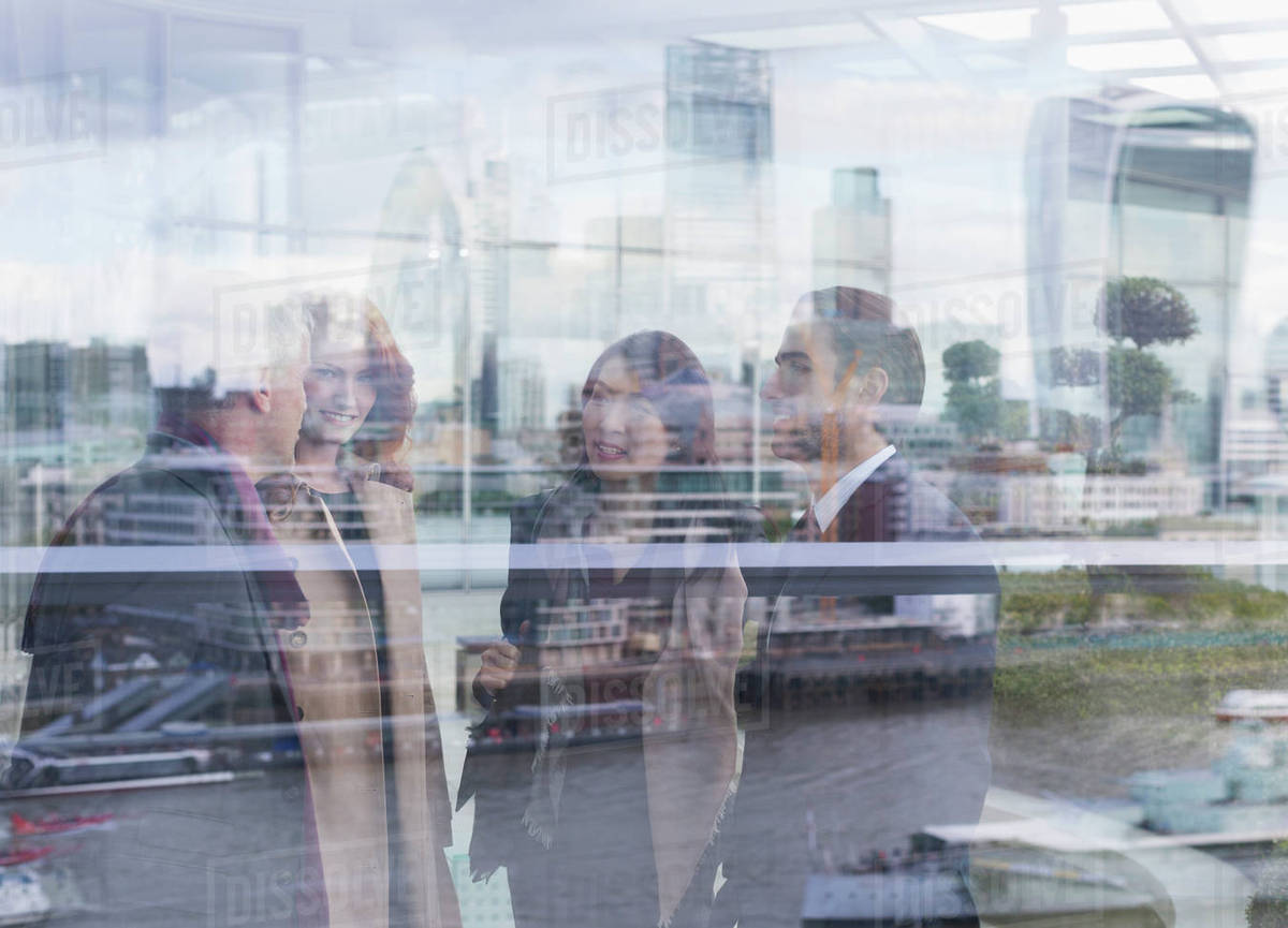 Business people talking at urban window with city view, London, UK ...
