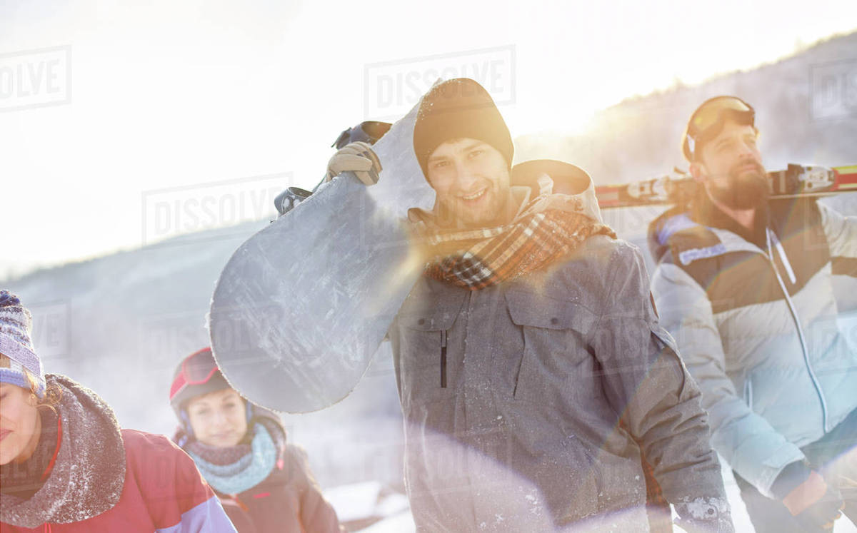 Portrait smiling snowboarder friends carrying snowboards - Royalty-free ...