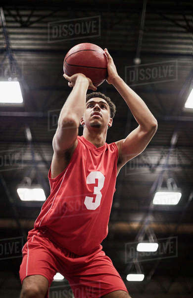 Focused young male basketball player shooting free throw - Royalty-free ...