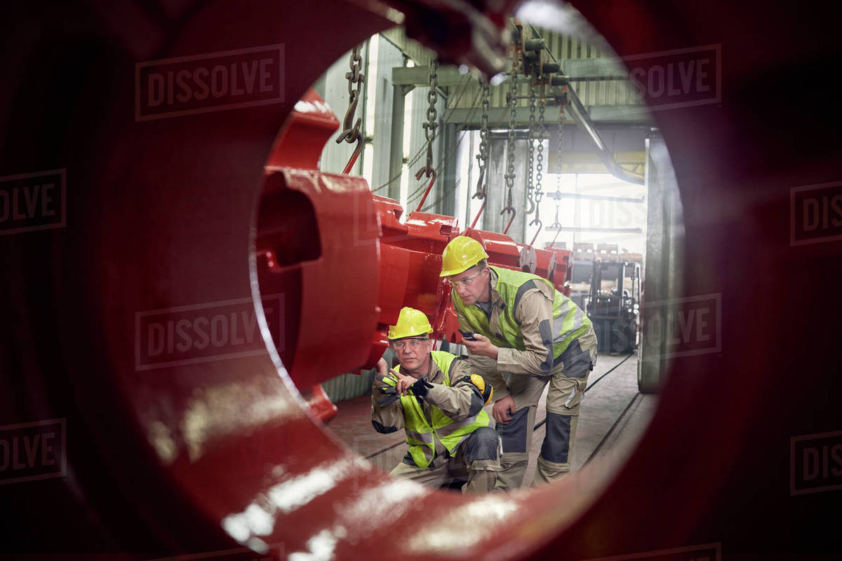 Steelworkers examining steel equipment in steel mill - Stock Photo ...