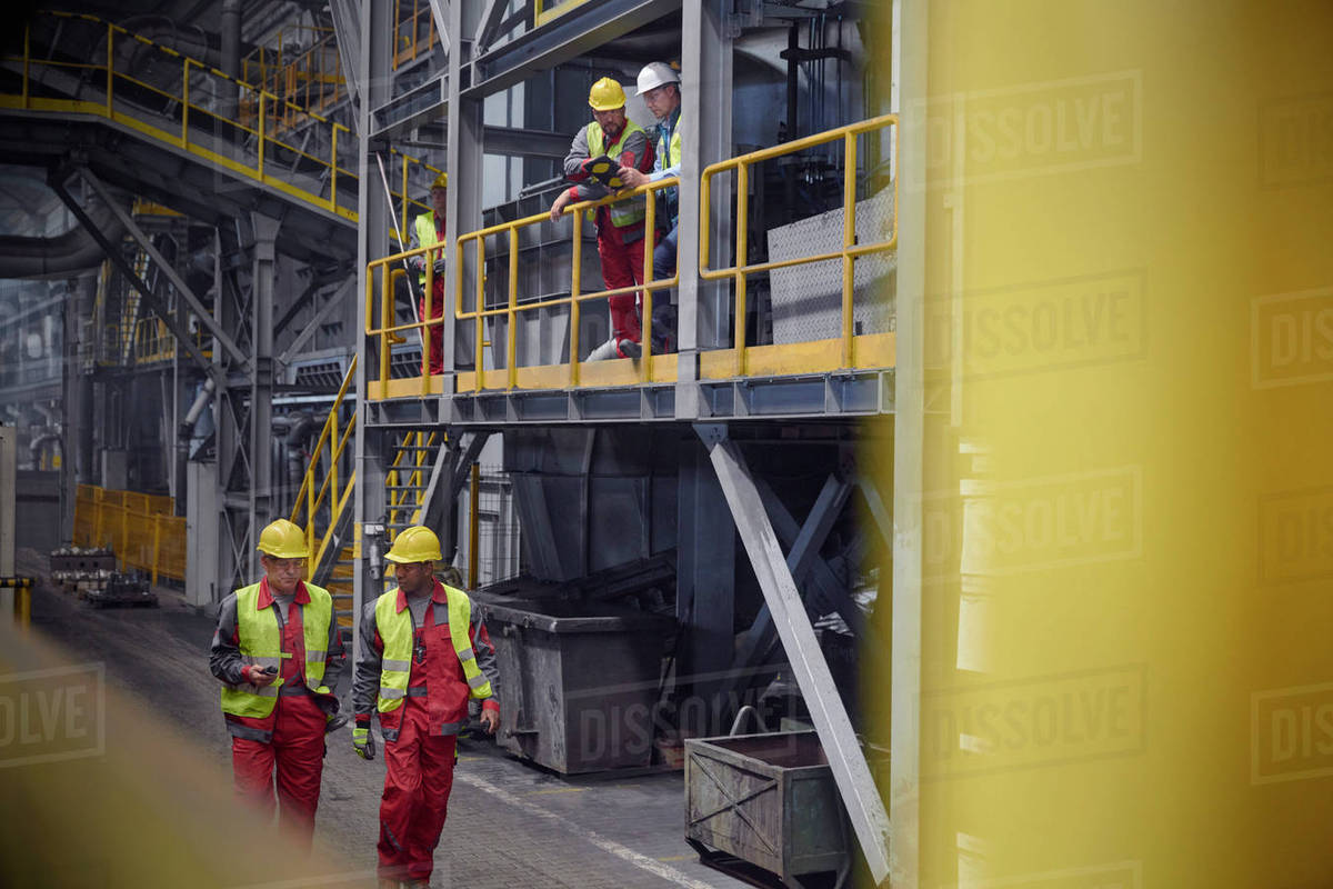Steelworkers talking and walking in steel mill - Royalty-free Stock ...