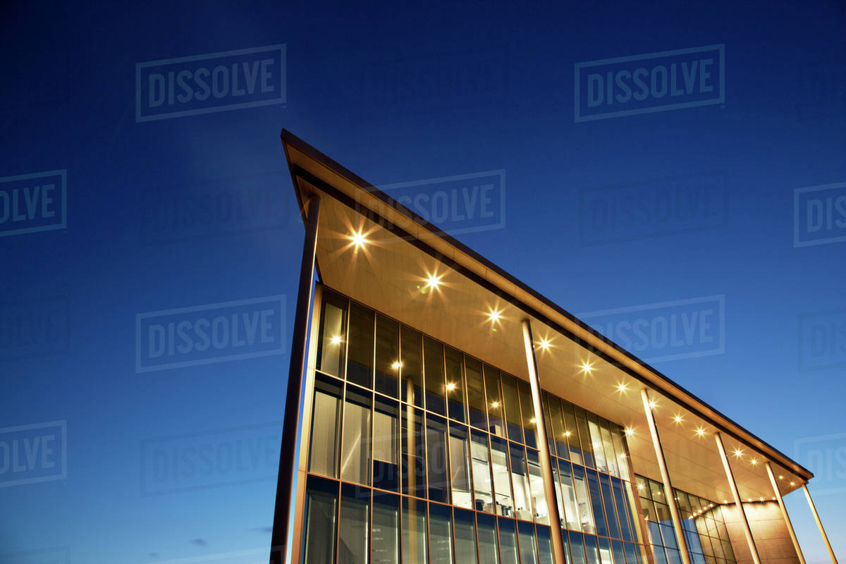 Modern building illuminated at dusk - Stock Photo - Dissolve