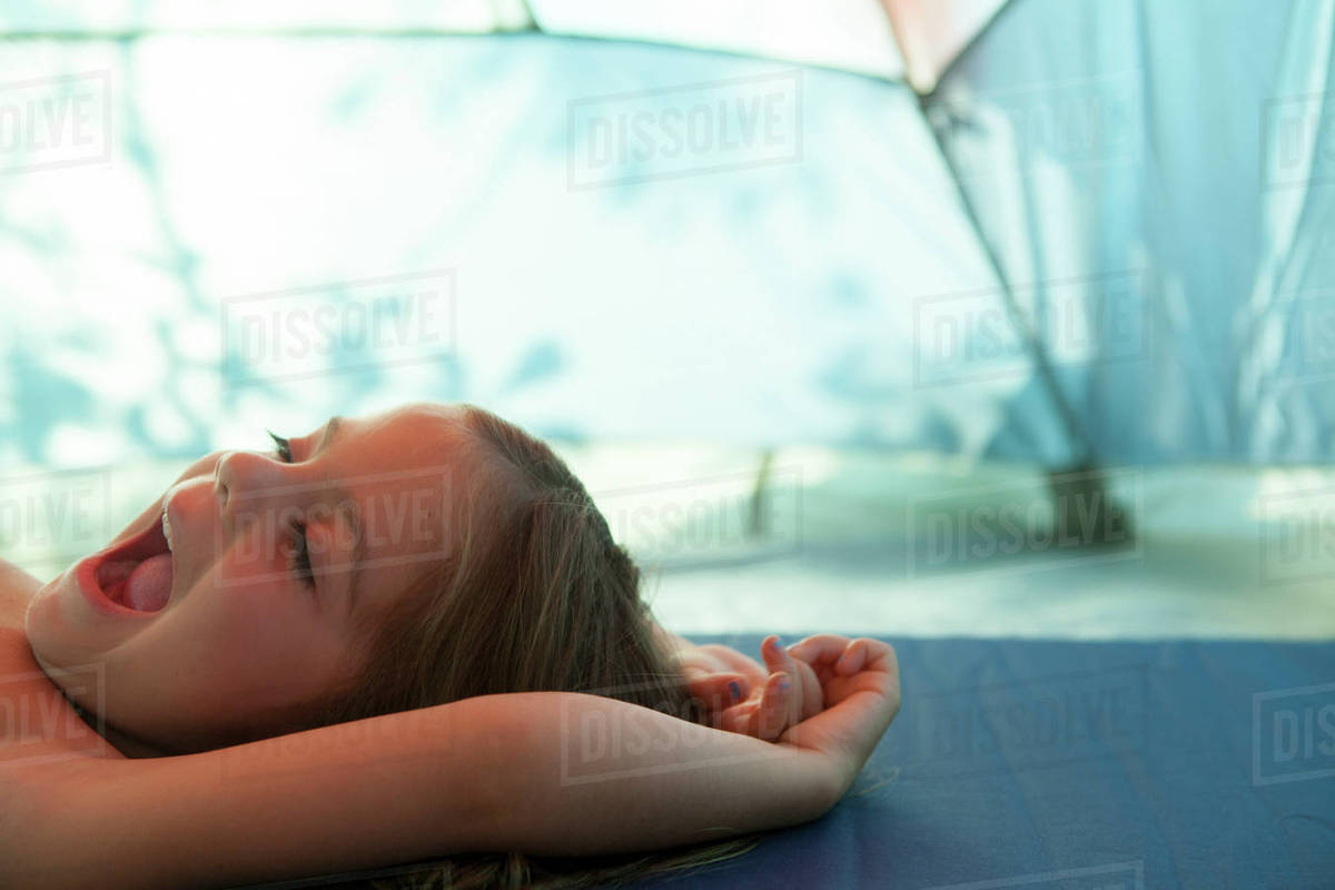 Tired girl yawning, resting inside tent - Royalty-free Stock Photo ...
