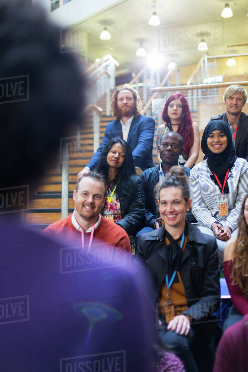 Smiling conference audience listening to speaker - Stock Photo - Dissolve