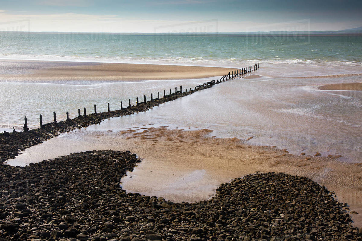 Remote ocean beach with craggy jetty, Heysham, Lancs, UK - Stock Photo ...