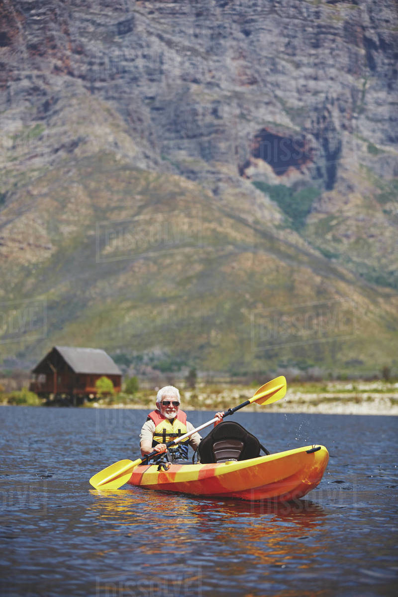 Active senior man kayaking on sunny summer lake - Royalty-free Stock ...