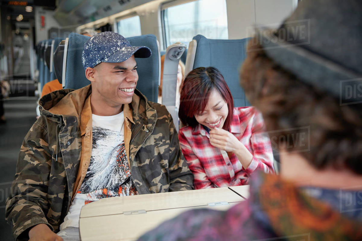 Young couple laughing on passenger train - Royalty-free Stock Photo ...