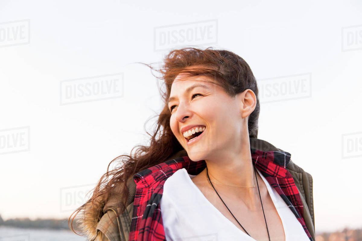 Smiling, enthusiastic woman looking over shoulder - Royalty-free Stock ...