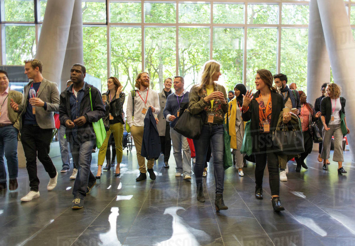 Business people arriving at conference, walking in lobby - Royalty-free ...