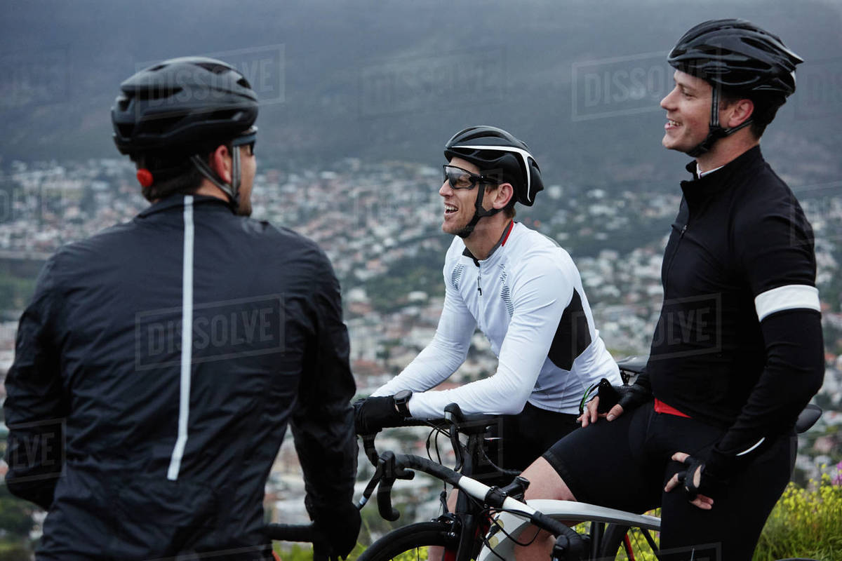 Male cyclist friends taking a break, talking - Royalty-free Stock Photo ...