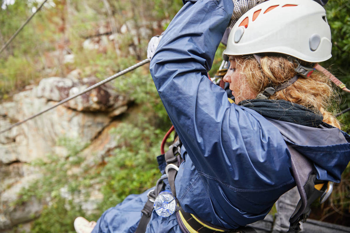 Woman zip lining - Stock Photo - Dissolve