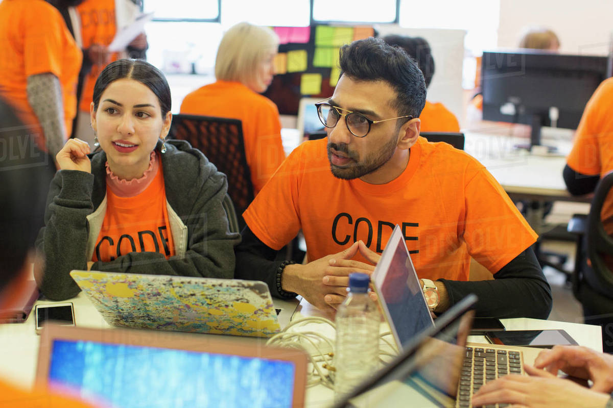 Hackers coding for charity at hackathon - Stock Photo - Dissolve