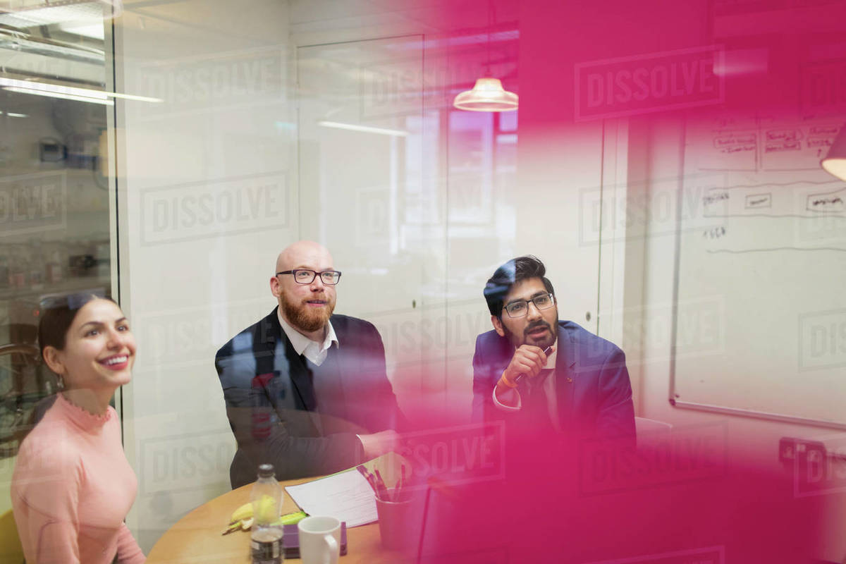 Attentive business people listening in conference room meeting ...