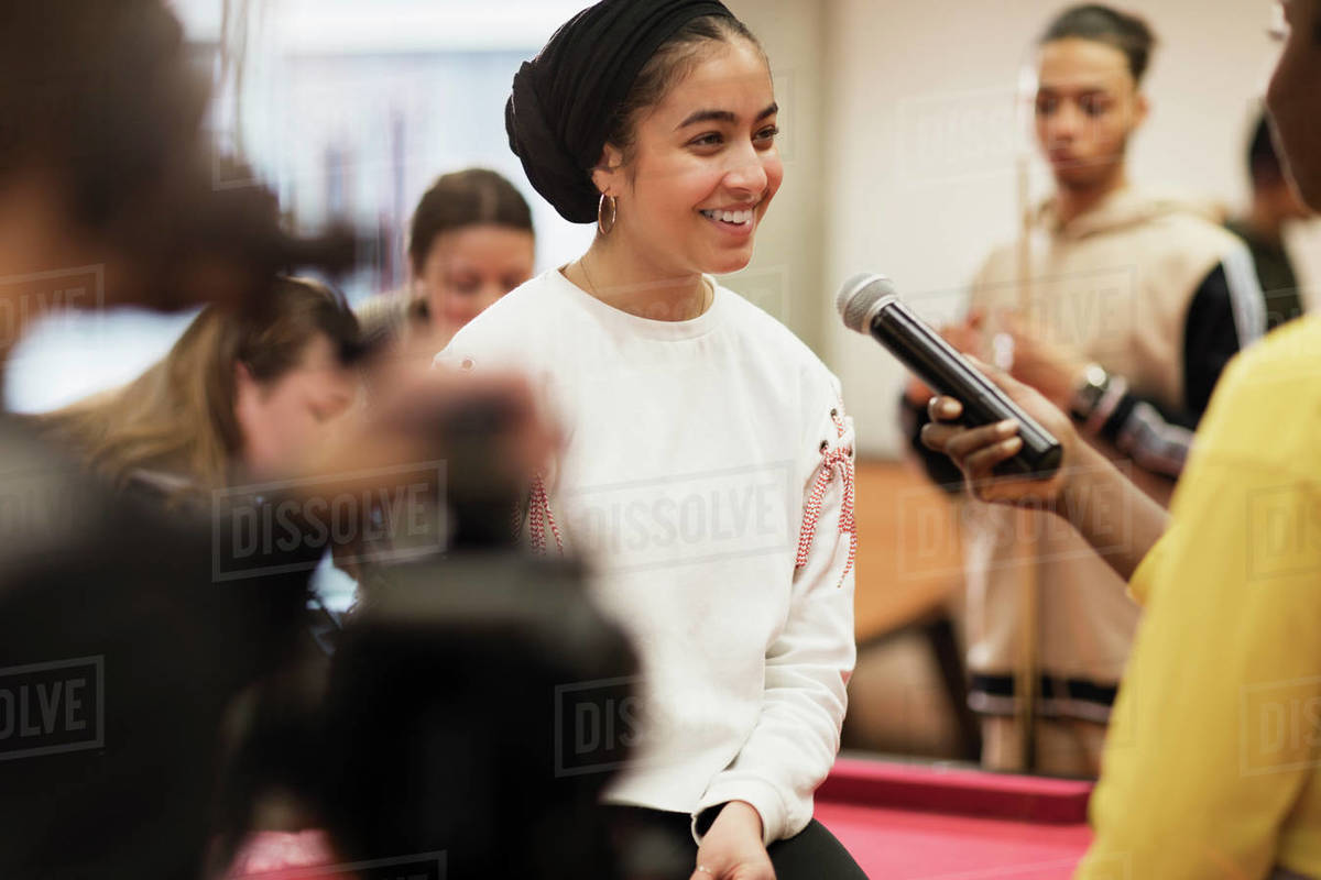 Smiling teenage girl being interviewed for vlog - Royalty-free Stock ...