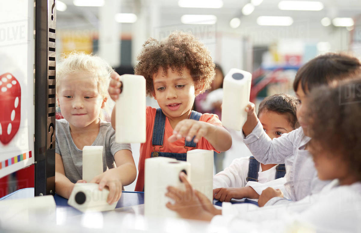 Kids playing with large dice in science center - Stock Photo - Dissolve