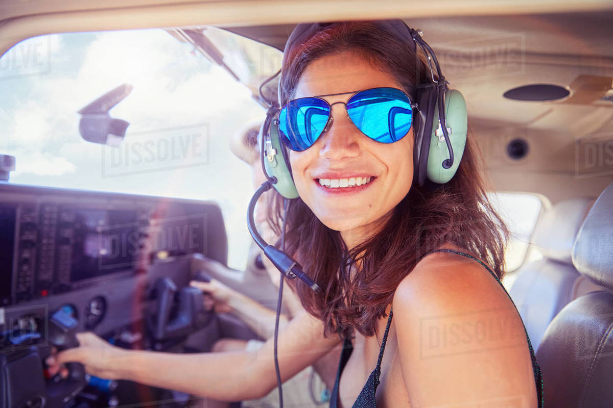 Portrait smiling, confident young woman flying airplane - Stock Photo ...