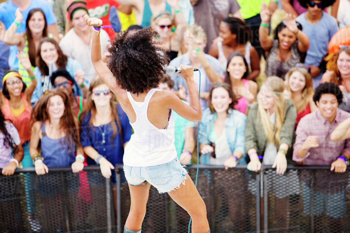 Fans watching performer sing at music festival - Royalty-free Stock ...