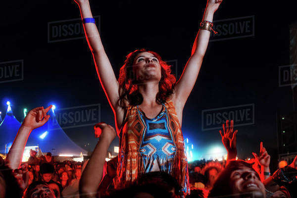 Cheering woman on manÍs shoulders at music festival - Stock Photo ...