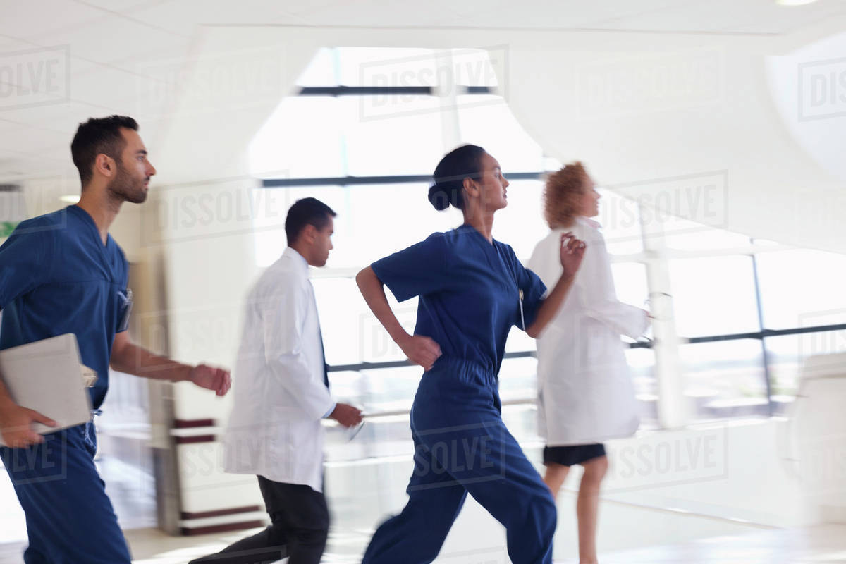 Hospital staff running down hallway - Royalty-free Stock Photo | Dissolve