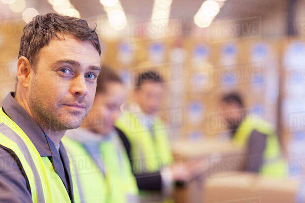 Worker standing in warehouse - Royalty-free Stock Photo | Dissolve