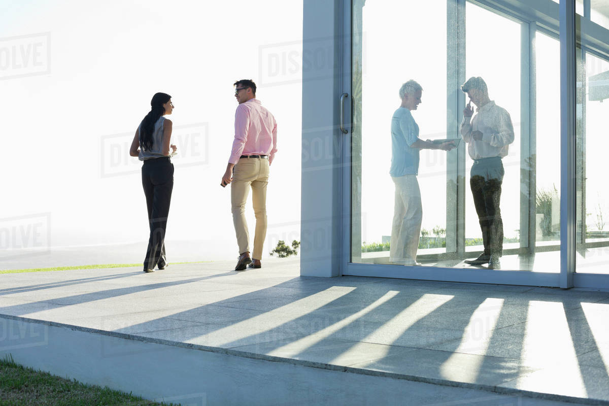 Business people talking outside office - Stock Photo - Dissolve