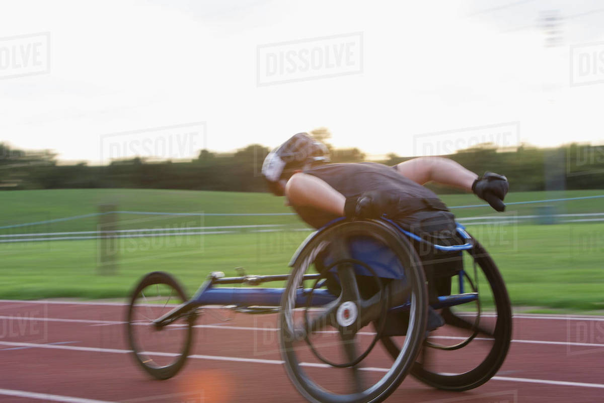 Paraplegic athlete speeding along sports track in wheelchair race ...