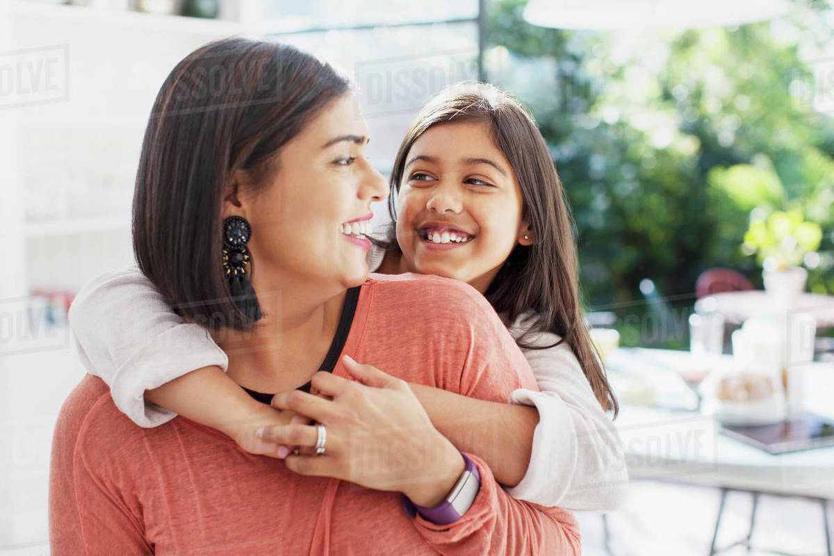 Happy, affectionate mother and daughter hugging - Royalty-free Stock Photo | Dissolve