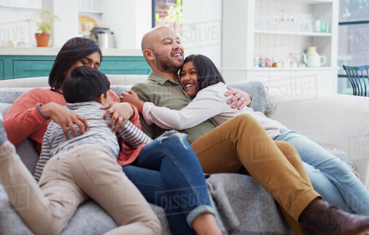 Happy, affectionate family on living room sofa - Royalty-free Stock ...