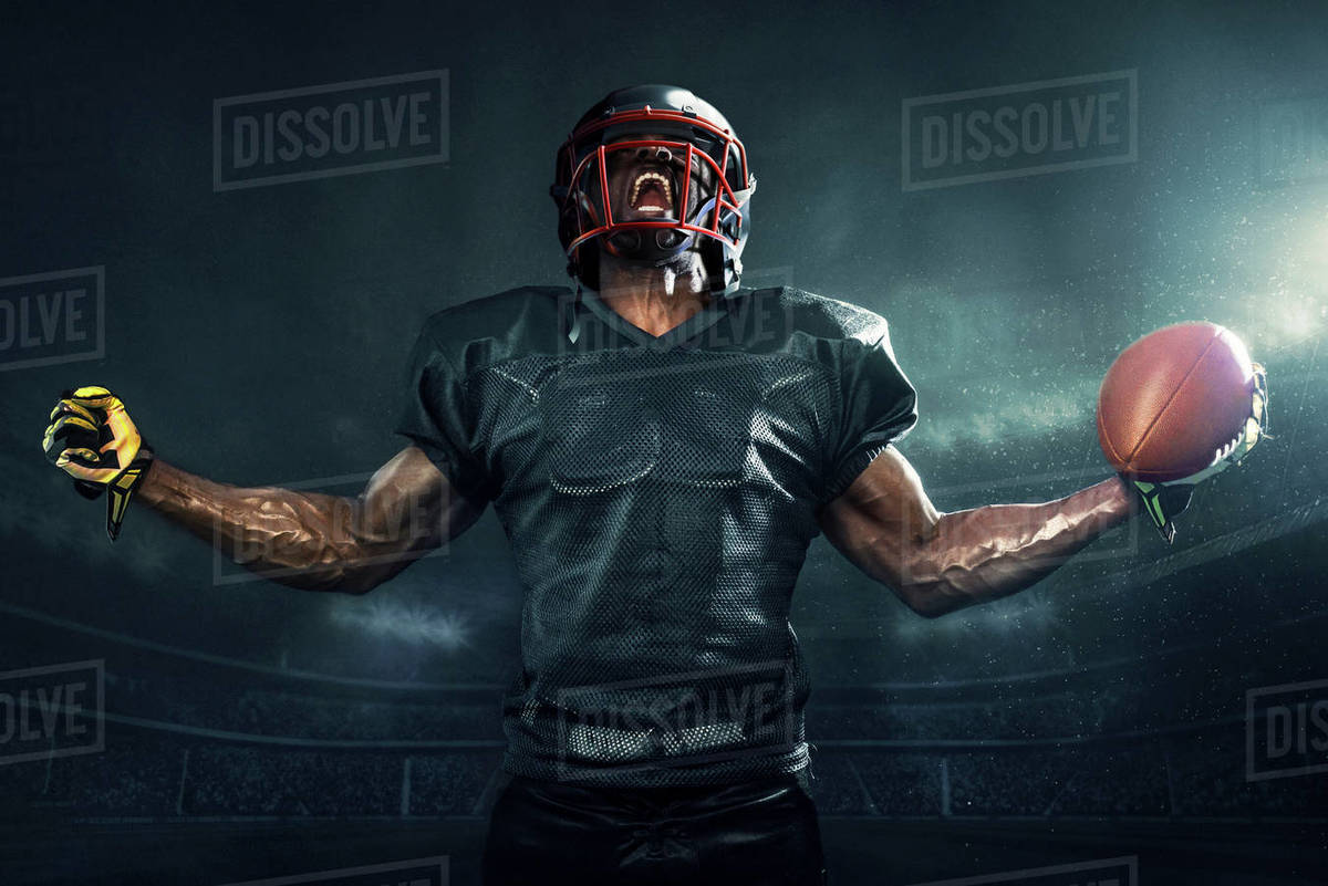 Muscular football player cheering - Royalty-free Stock Photo | Dissolve