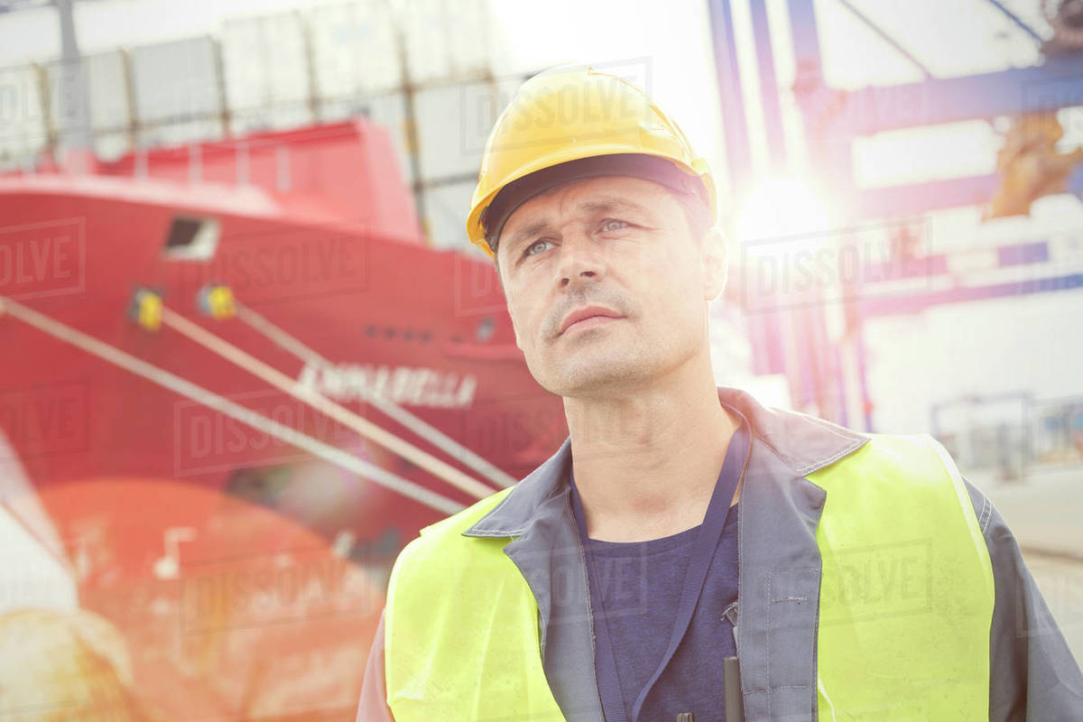 Serious dock worker below container ship at commercial dock - Royalty ...