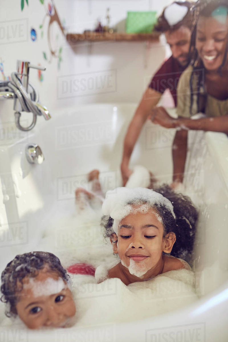 Parents giving daughters bubble bath - Royalty-free Stock Photo | Dissolve