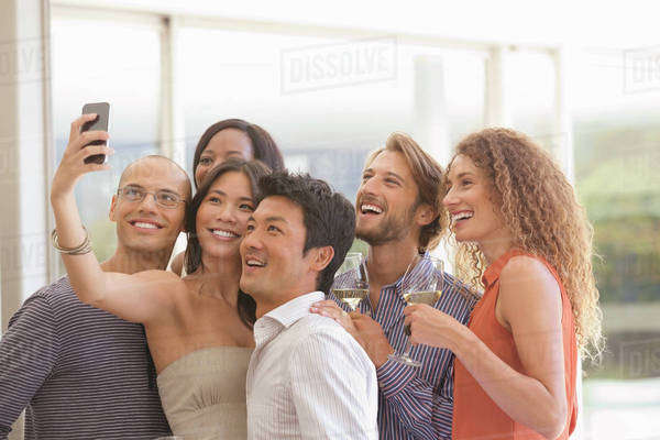 Friends taking picture together - Stock Photo - Dissolve