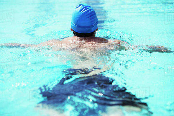 Swimmer floating in pool - Stock Photo - Dissolve