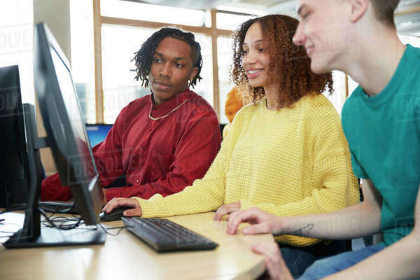 College students using computer in library - Stock Photo - Dissolve