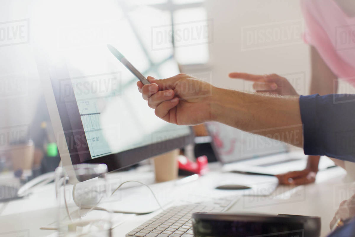 Architects working at computer in office - Stock Photo - Dissolve
