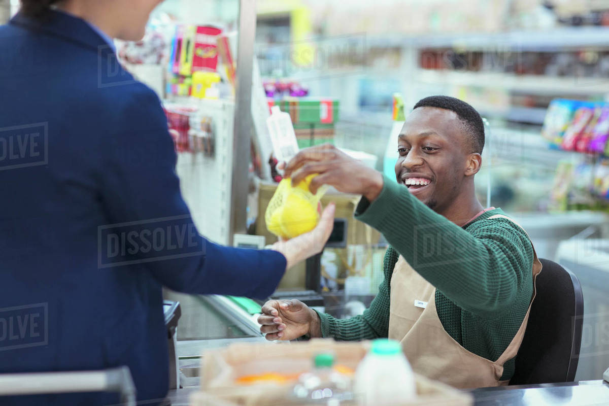 Cashier helping customer at supermarket checkout - Royalty-free Stock ...