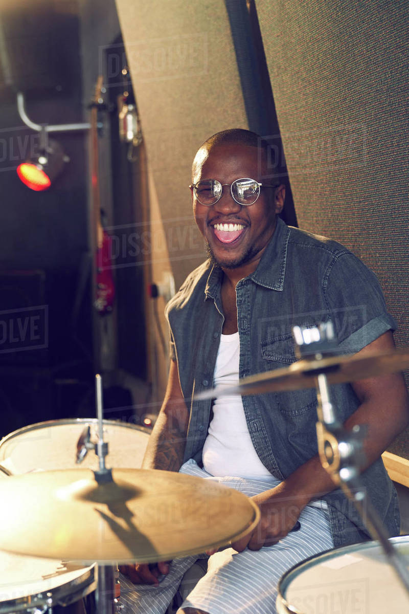 Portrait happy male drummer practicing at drums - Royalty-free Stock ...