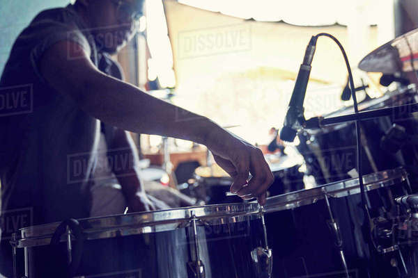 Male drummer adjusting drums in recording studio - Royalty-free Stock ...