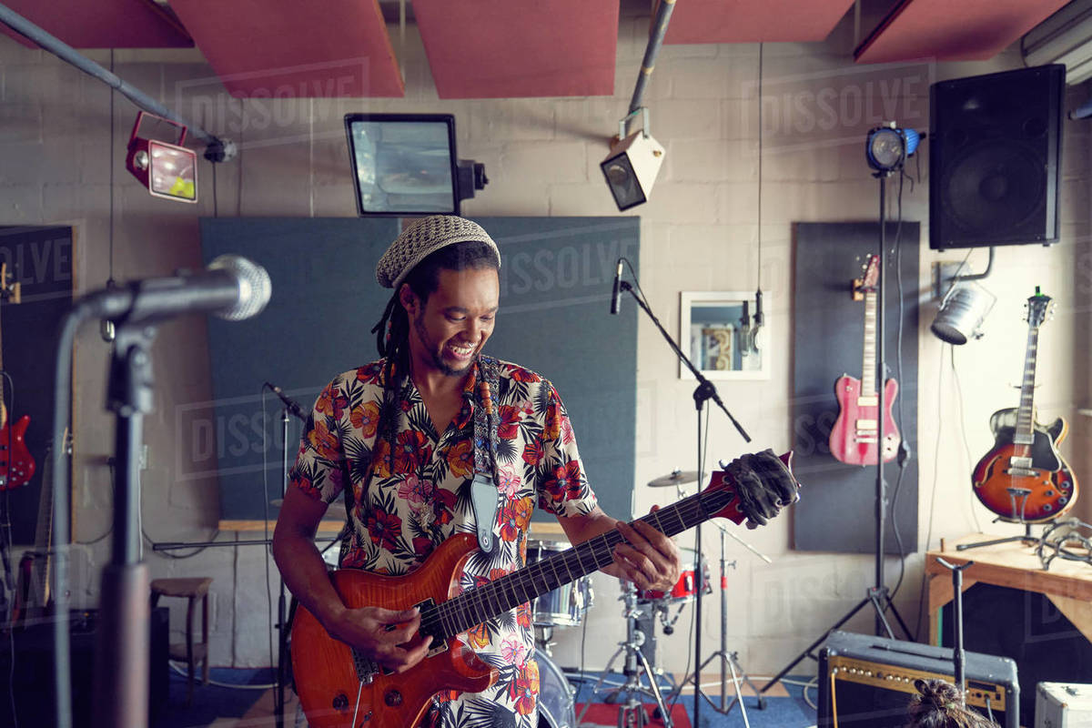 Male musician playing electric guitar in recording studio - Stock Photo ...