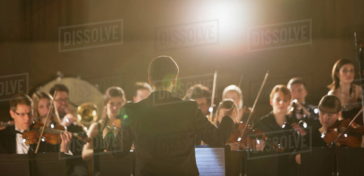 Conductor leading orchestra - Stock Photo - Dissolve