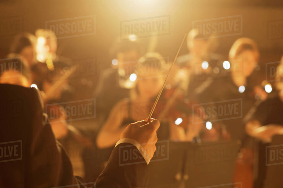 Conductor leading orchestra - Royalty-free Stock Photo | Dissolve