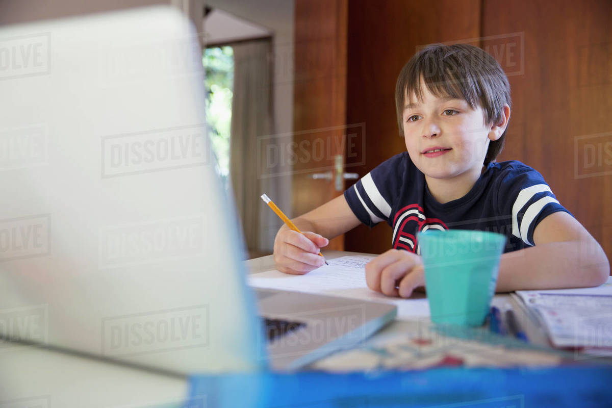 Boy e-learning at laptop - Royalty-free Stock Photo | Dissolve