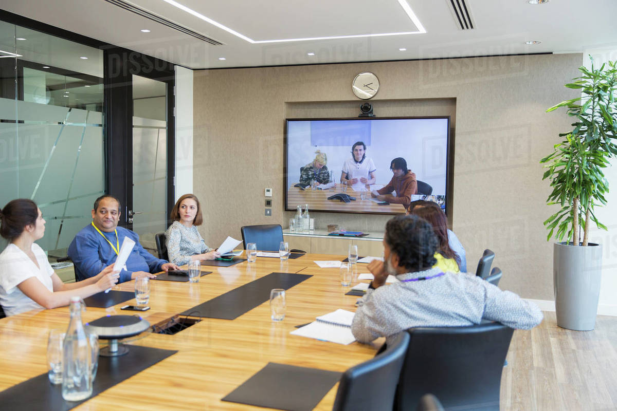 Business people video conferencing in conference room meeting - Royalty ...