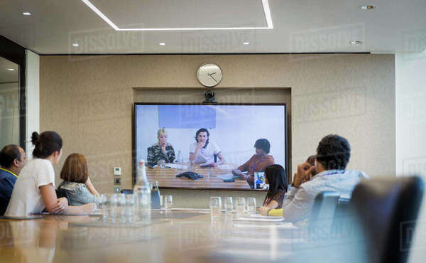 Business people video conferencing in conference room meeting - Royalty ...