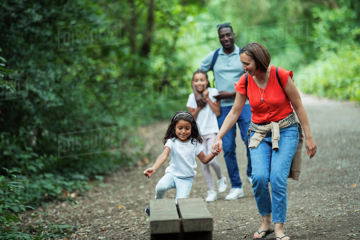 Happy family walking on trail in woods - Royalty-free Stock Photo ...